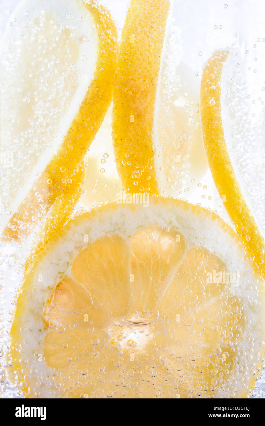 Sliced lemon in refreshing fizzy water Stock Photo - Alamy