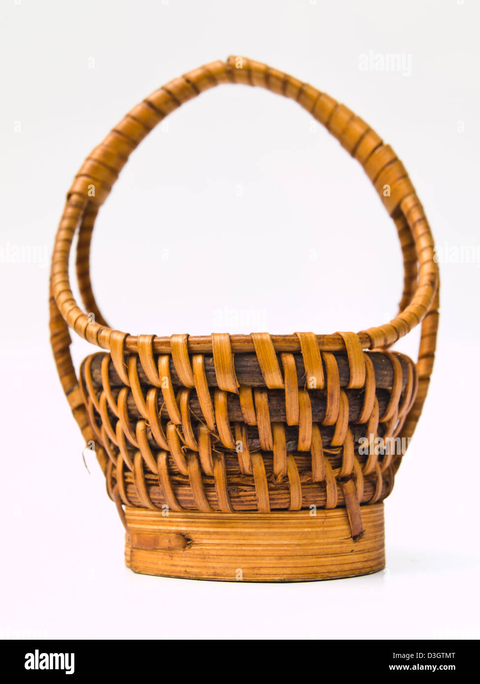 A yellow wicker basket isolated on white background Stock Photo - Alamy
