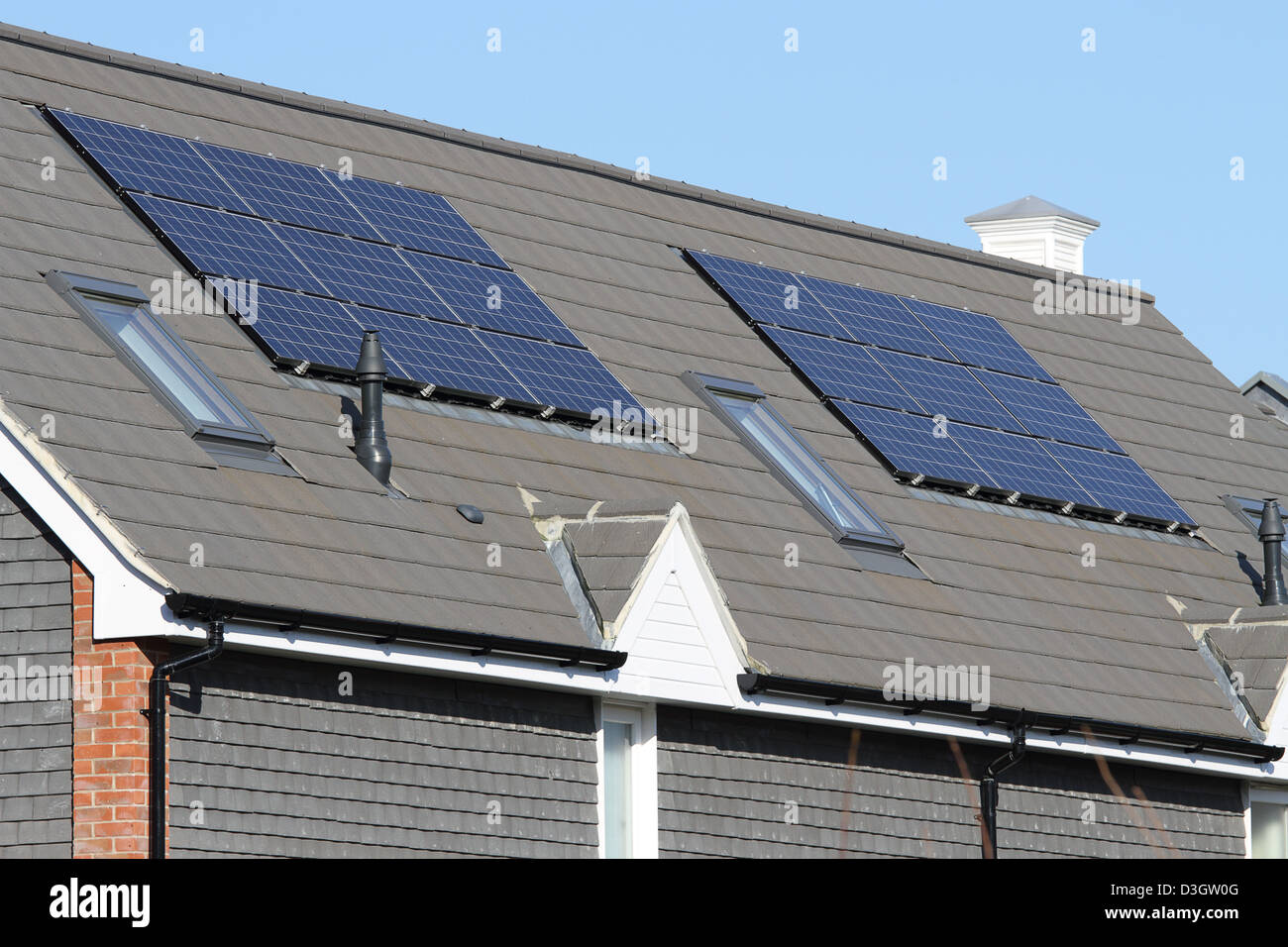 Solar photovoltaic panel arrays on house roof Stock Photo - Alamy