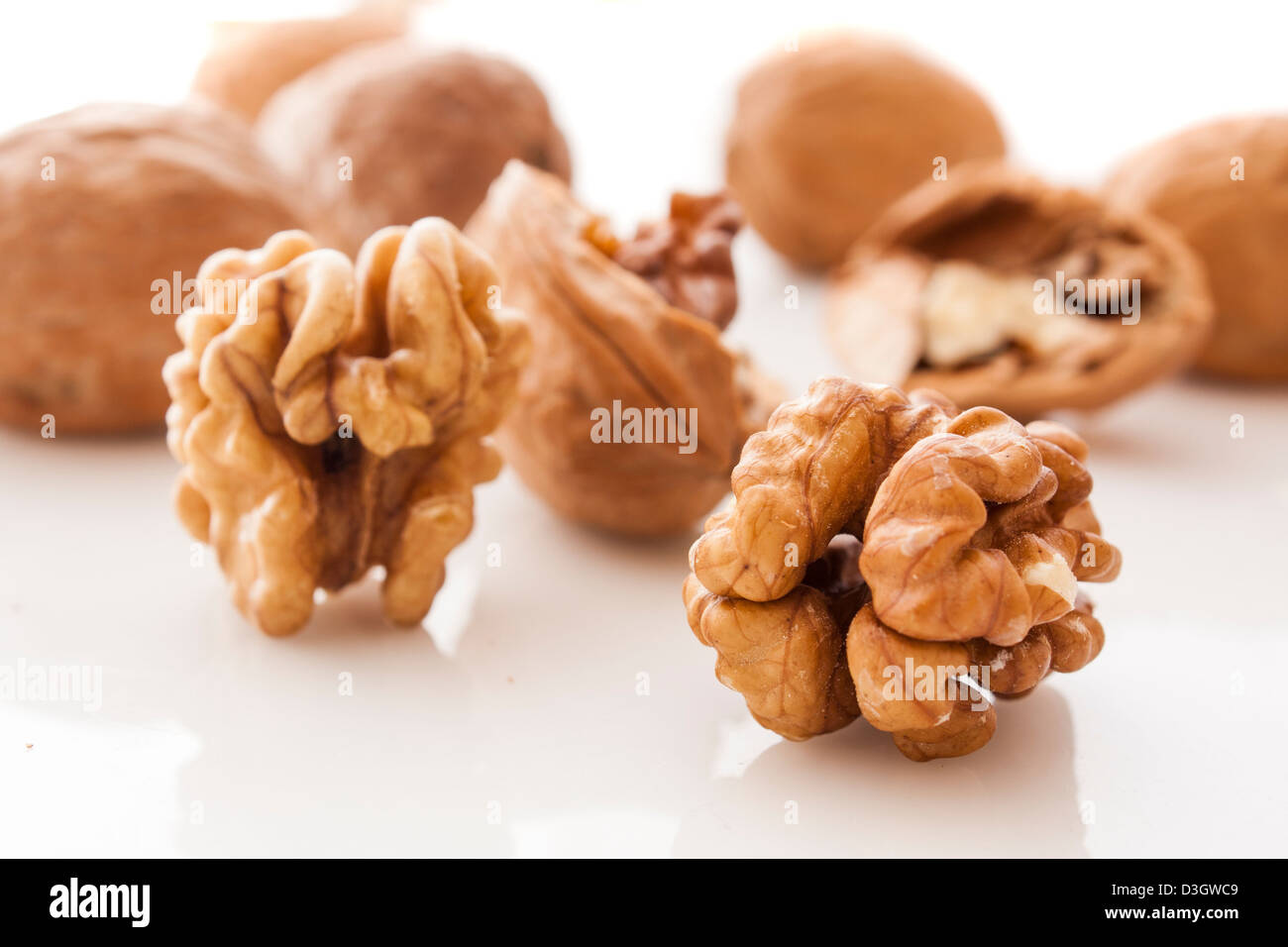 walnut and a cracked walnut on white background Stock Photo - Alamy