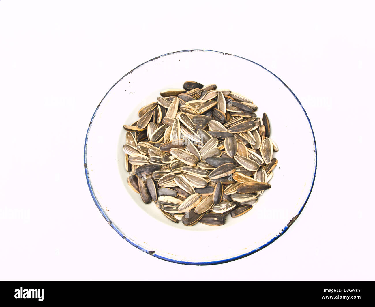 Sunflower seeds in a white dish isolated on white background as ...