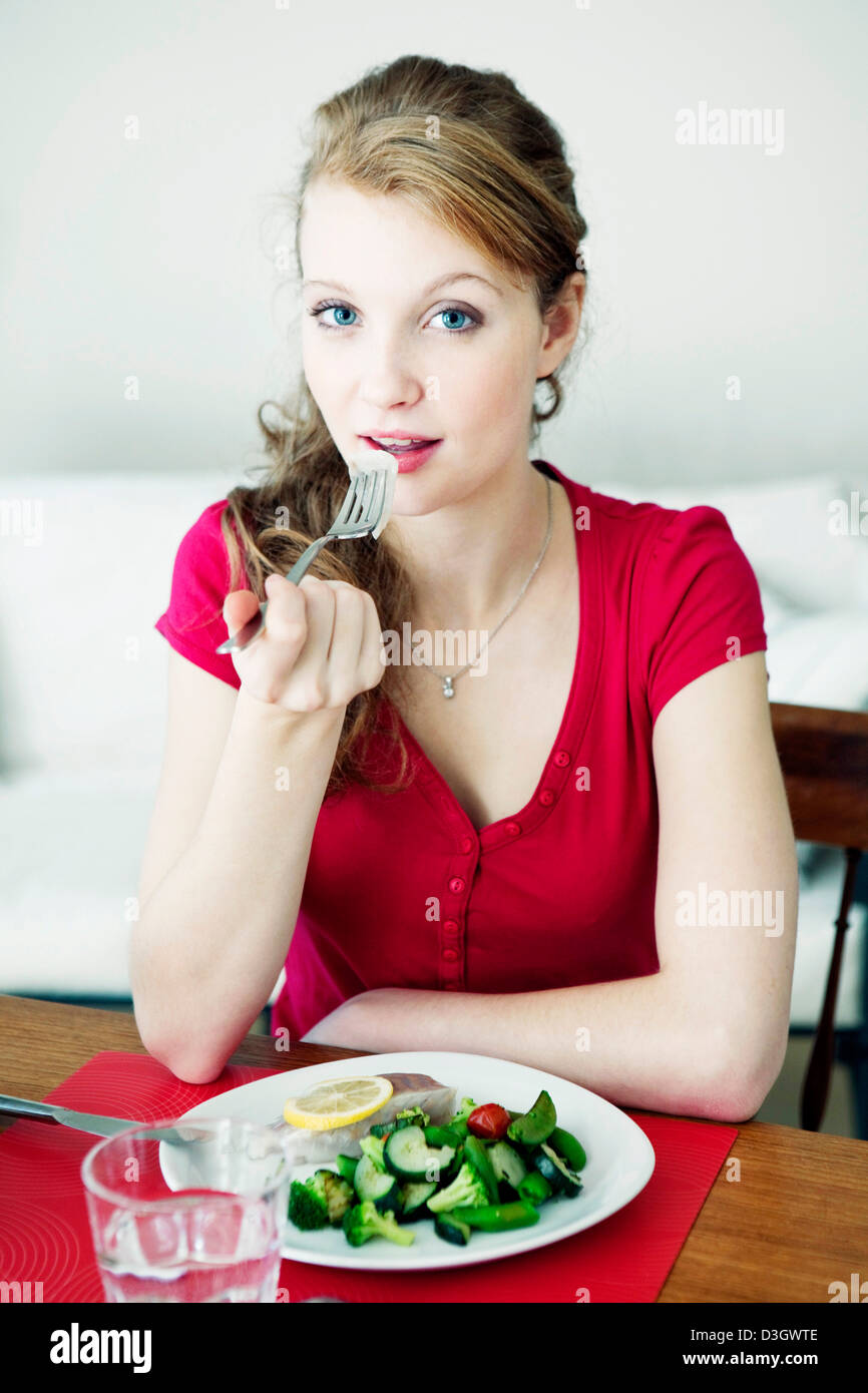 WOMAN EATING A MEAL Stock Photo - Alamy
