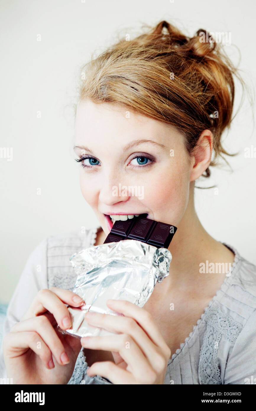 WOMAN EATING SWEETS Stock Photo - Alamy