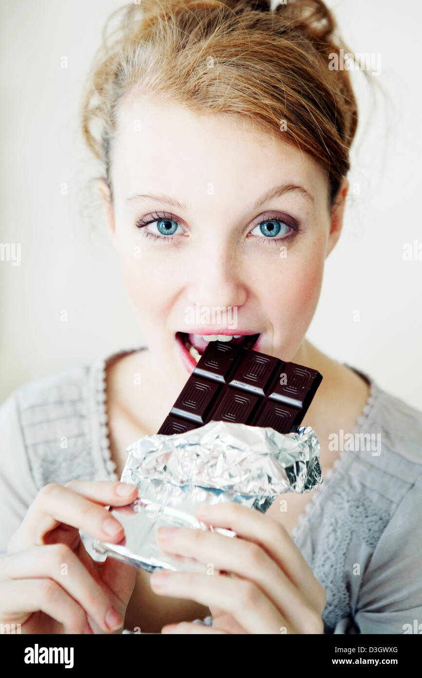 WOMAN EATING SWEETS Stock Photo - Alamy