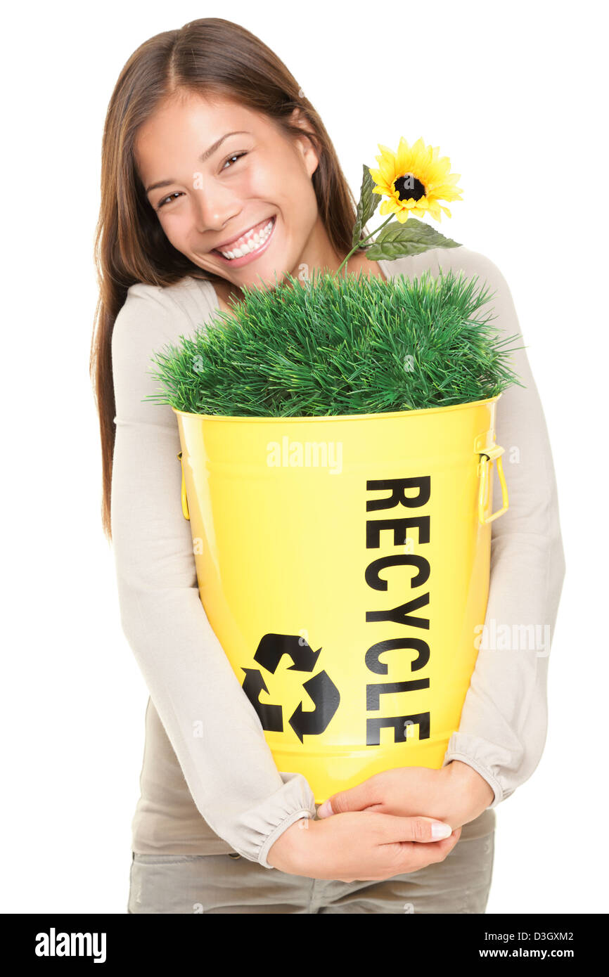 Portrait of woman showing recycle bin with grass and flower. Recycling ...
