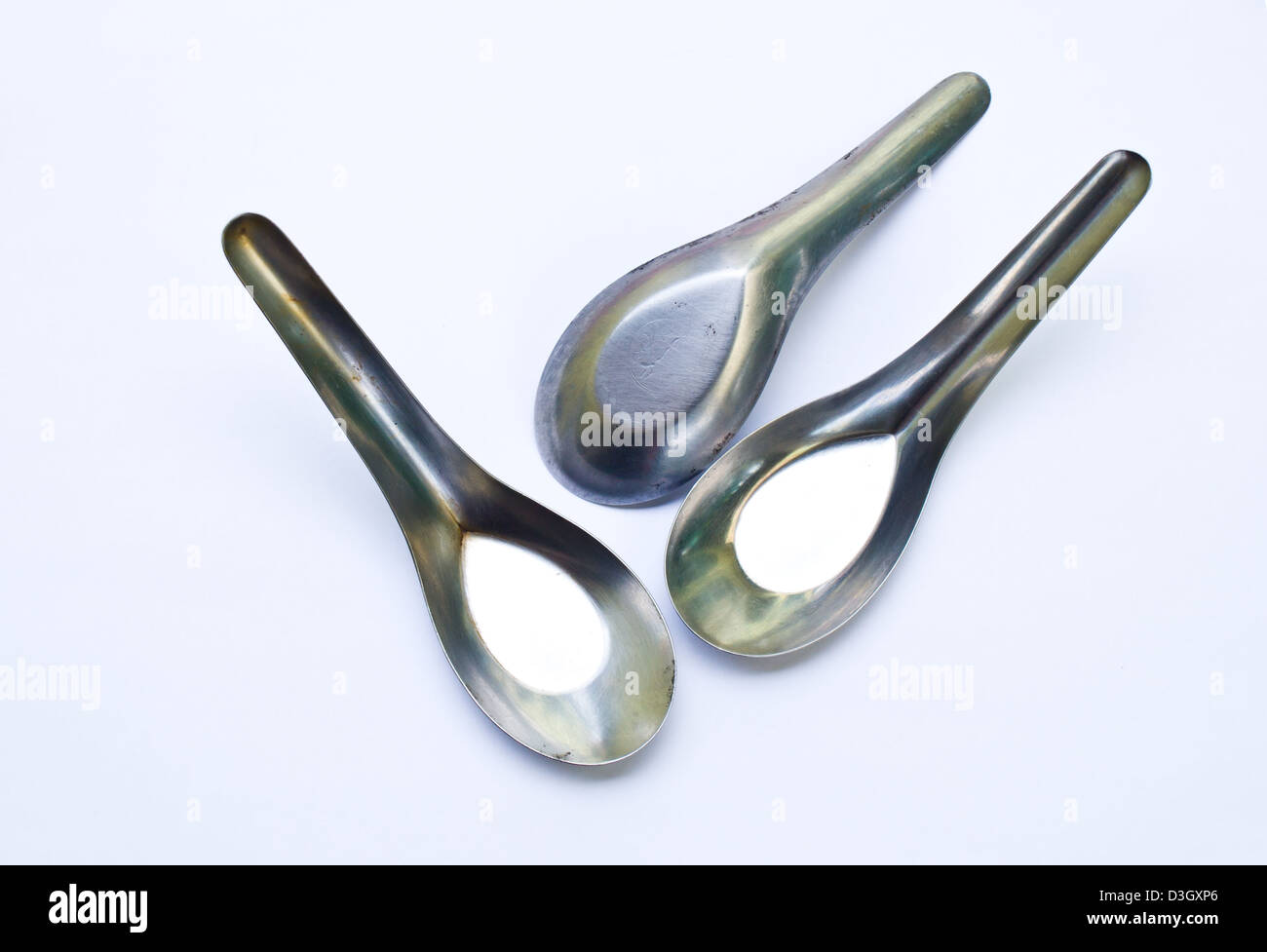 Used stainless steel spoons isolated on white background Stock Photo ...