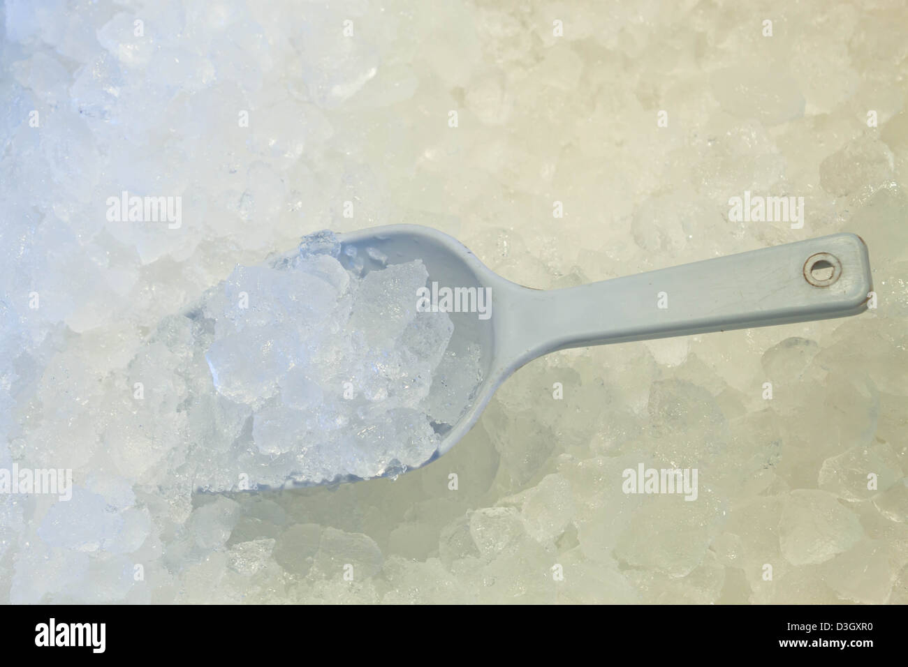 Ice scoop in fresh cool ice background Stock Photo - Alamy