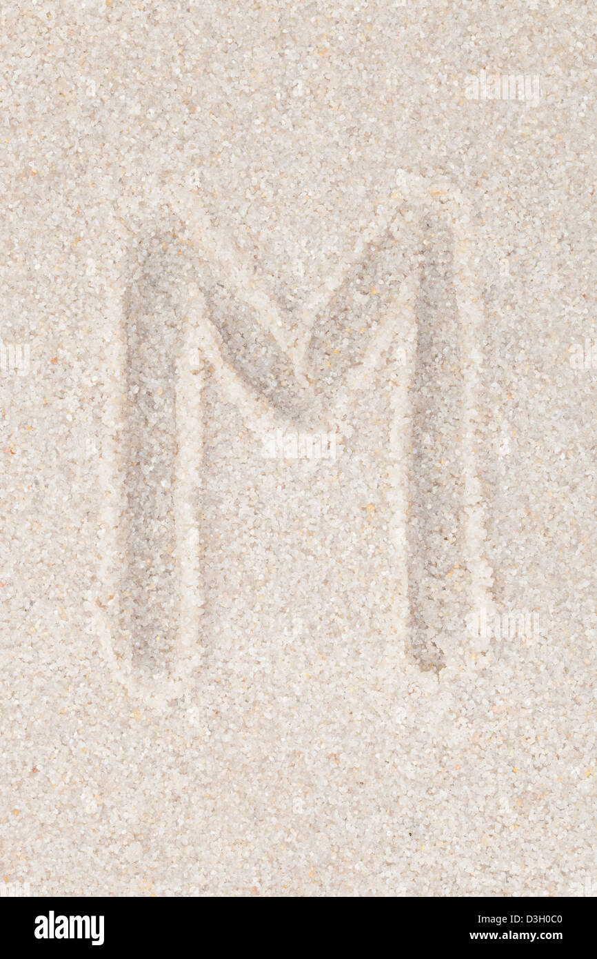 Alphabet writing on the sand - Letter M Stock Photo - Alamy