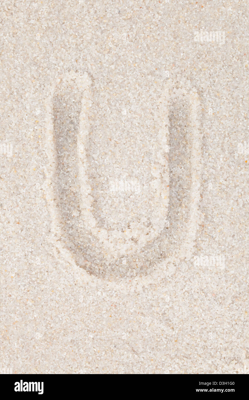 Alphabet writing on the sand - Letter U Stock Photo - Alamy