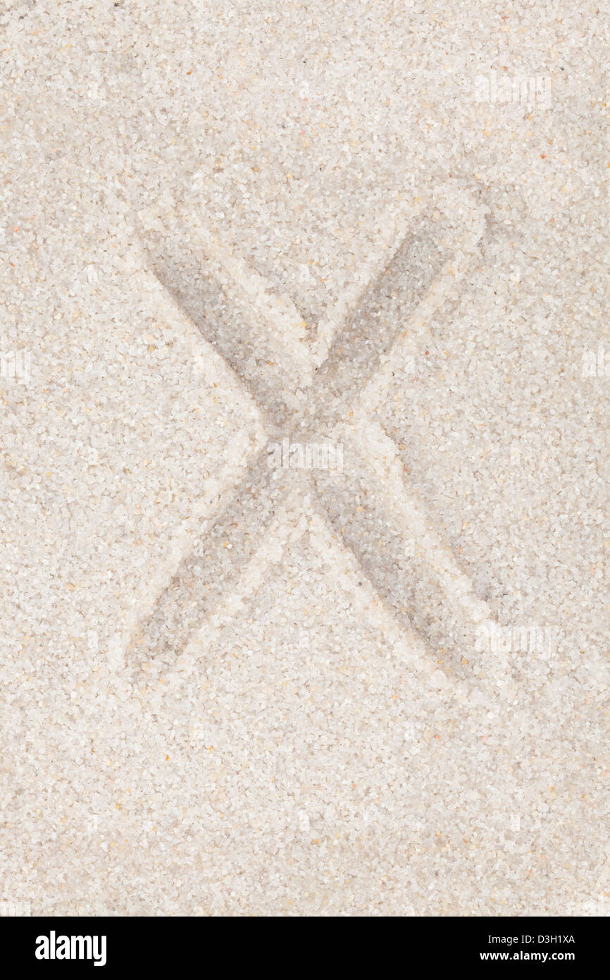 Alphabet writing on the sand - Letter X Stock Photo - Alamy