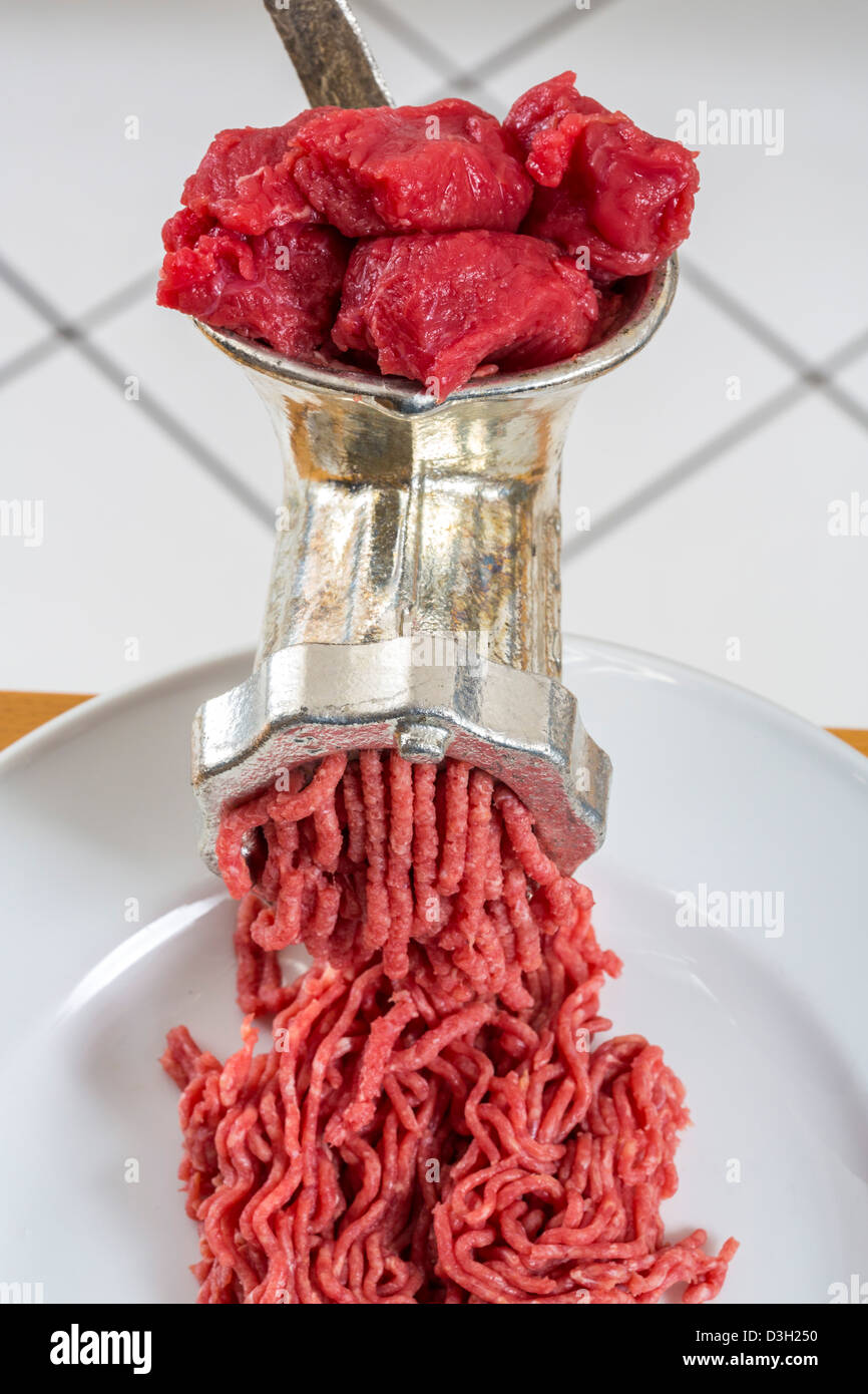 Meat grinder. Kitchen tool to mince meat Stock Photo - Alamy
