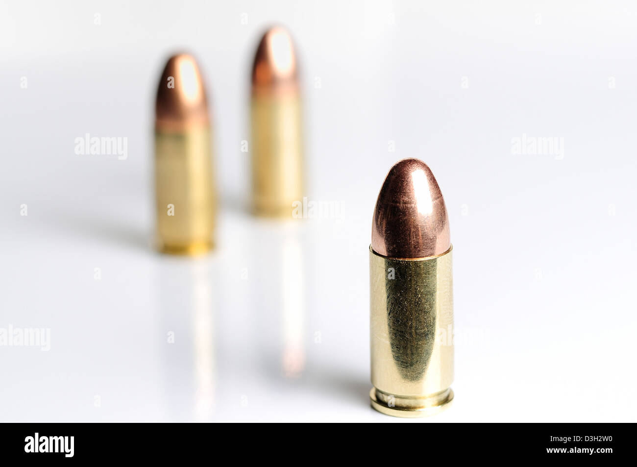 Three 9mm Winchester Luger bullets against white backdrop Stock Photo ...