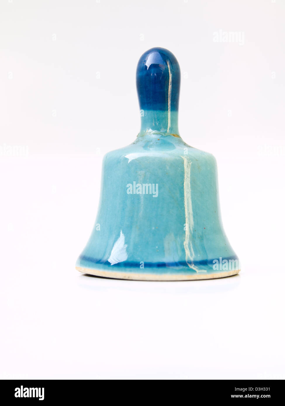 A miniature ceramic blue bell isolated on white, handicraft from the ...