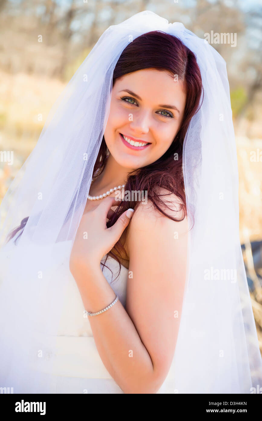 Smiling bride with veil portrait Stock Photo - Alamy