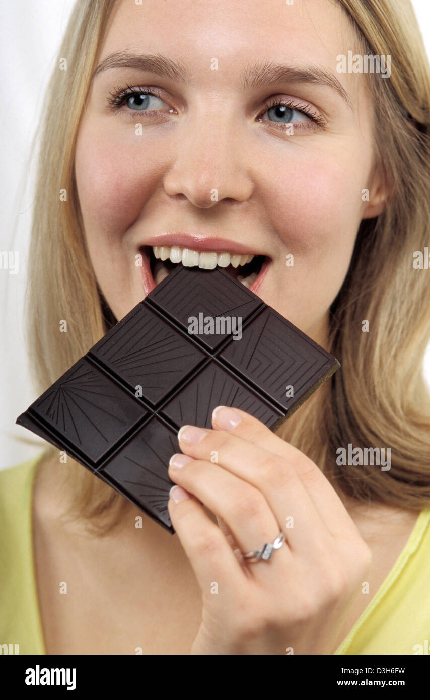 WOMAN EATING SWEETS Stock Photo - Alamy