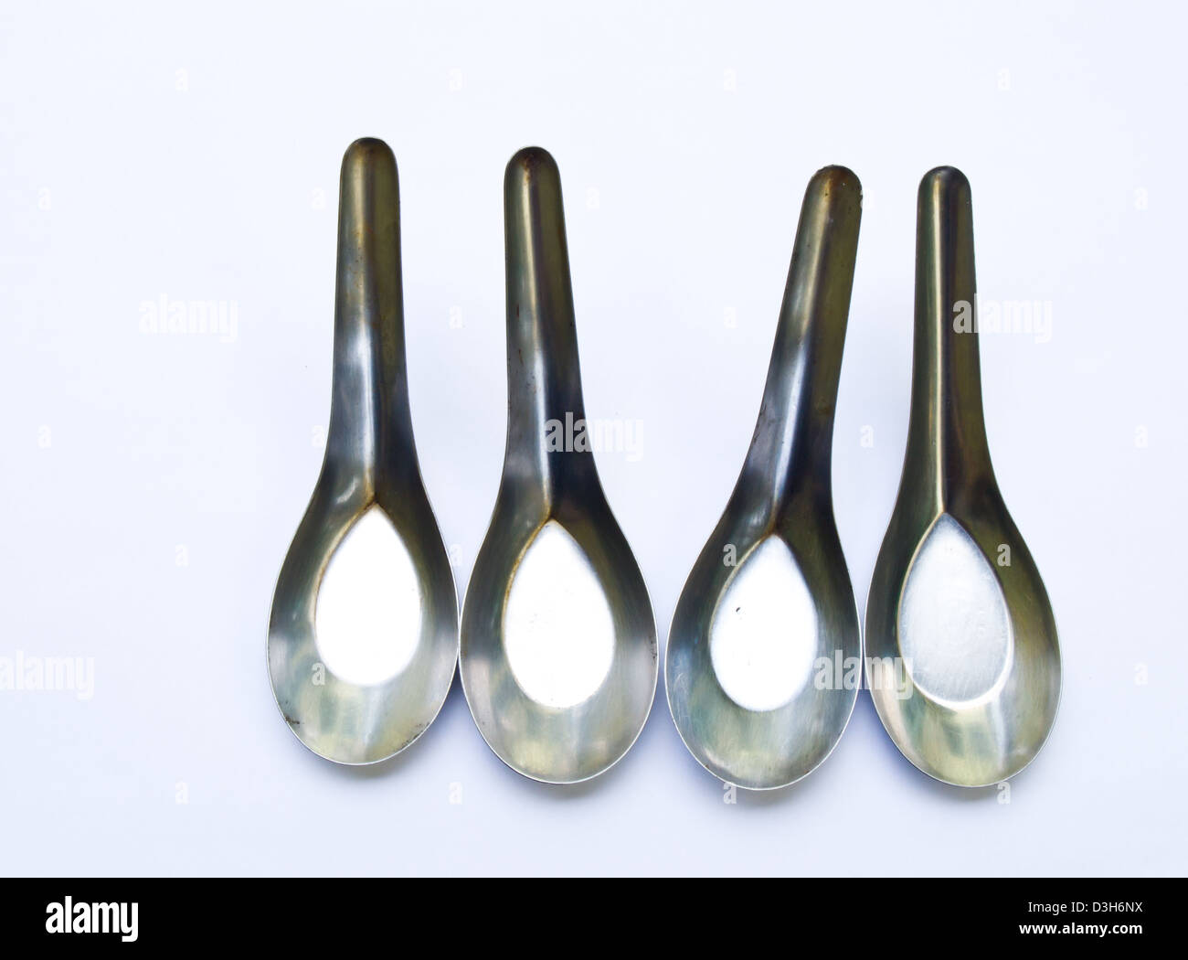 Used stainless steel spoons isolated on white background Stock Photo ...