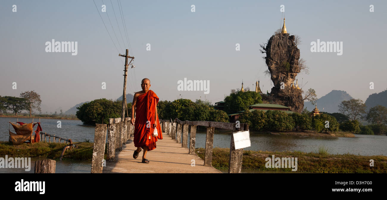 Monk walking on a Bridge at Kyauk Ka Lat Pagoda, Karst Mountains near ...