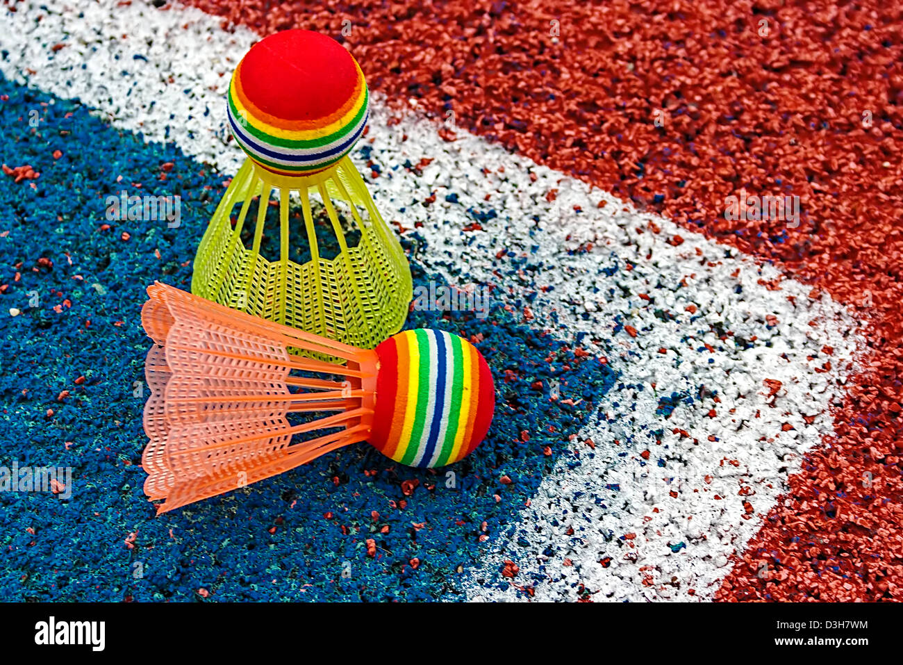 Badminton colored shuttlecocks placed in the corner of a synthetic ...
