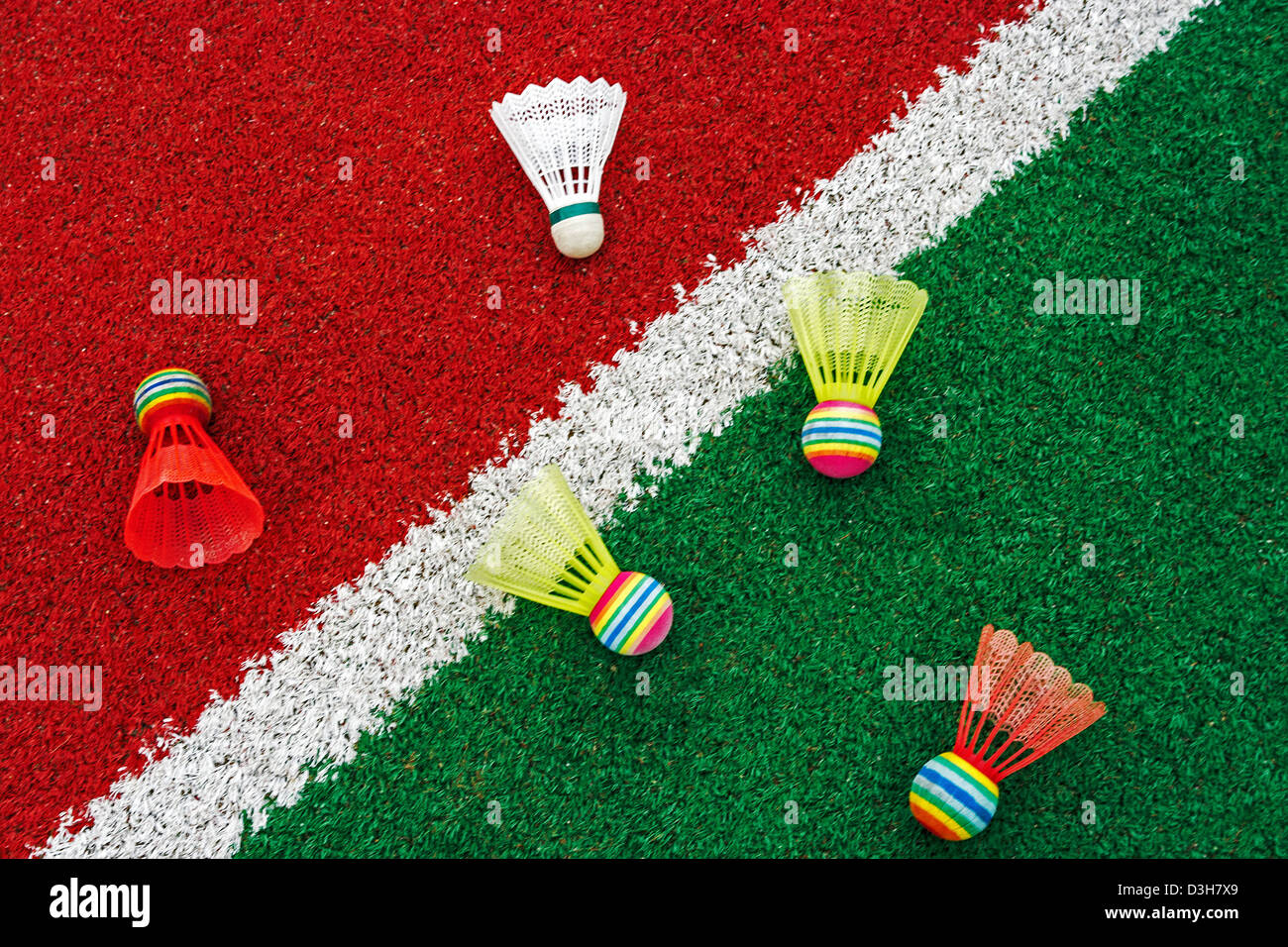 Badminton colored shuttlecocks, placed on synthetic field Stock Photo ...
