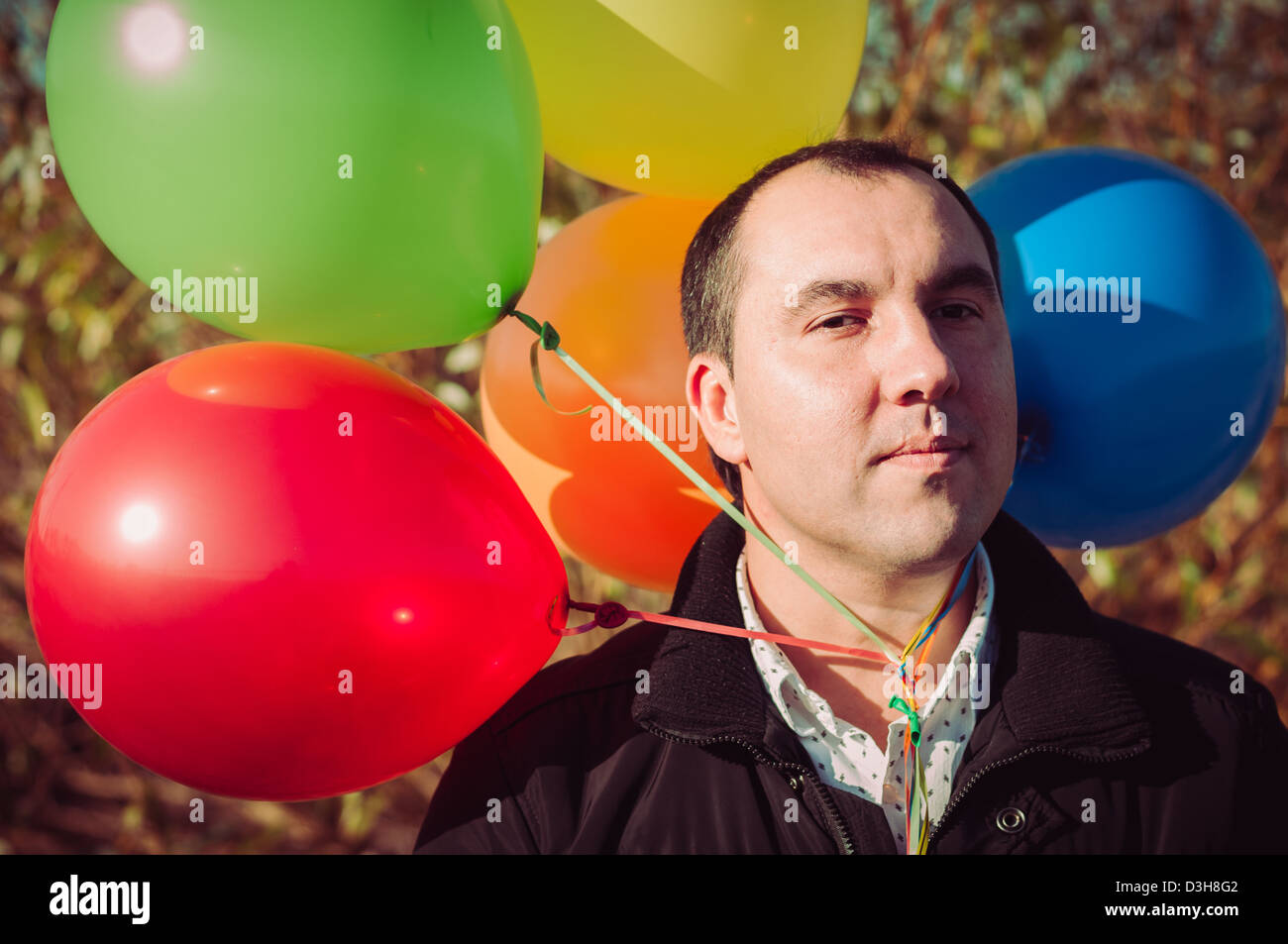 Young man with lot of balloons outdoor Stock Photo - Alamy