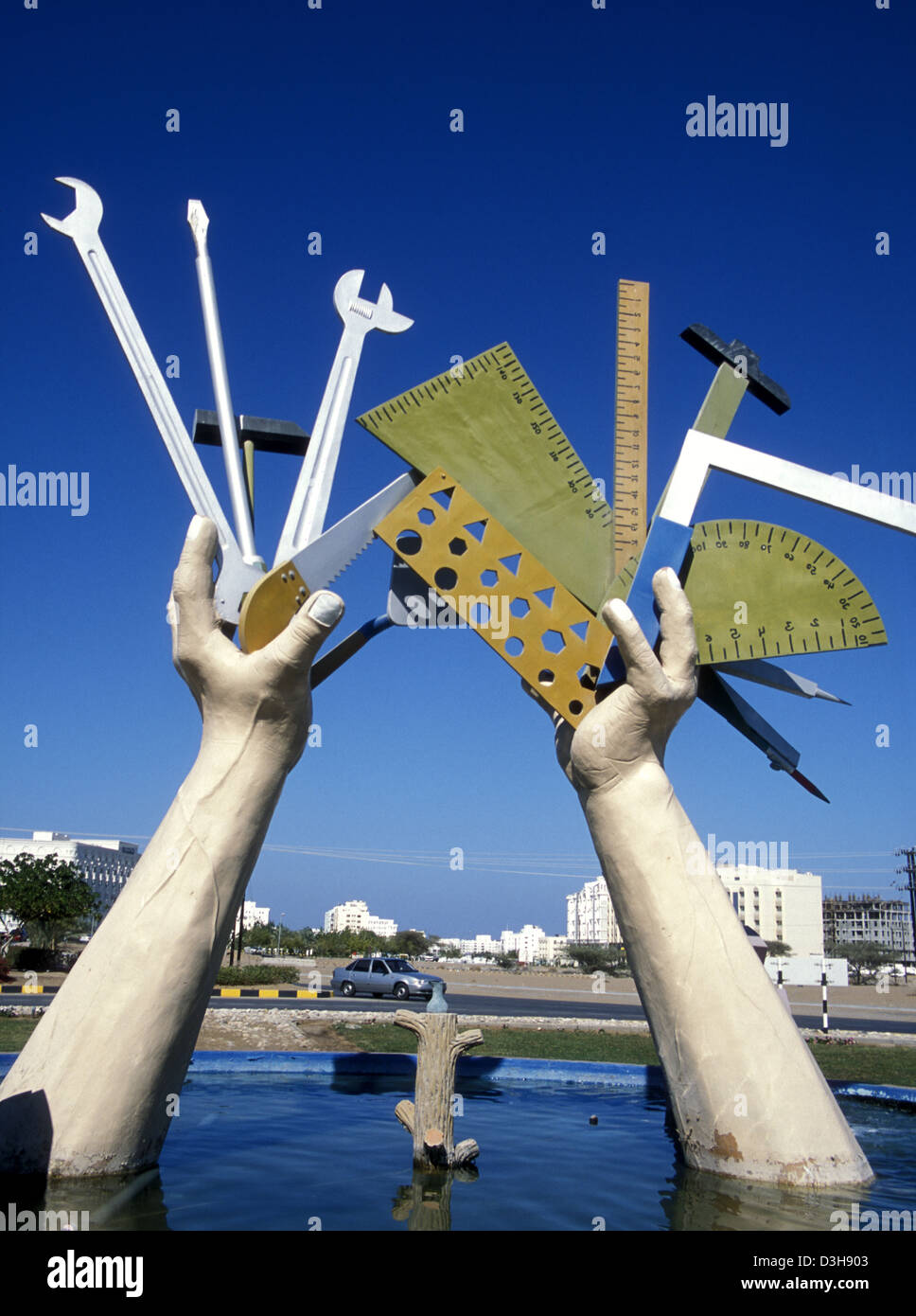 Worker roundabout with hands holding tools in Muscat, Oman Stock Photo ...