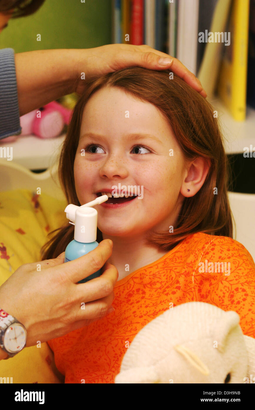 CHILD USING SPRAY IN MOUTH Stock Photo - Alamy