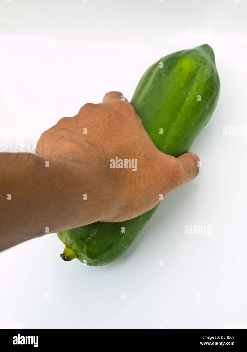 Ripe papaya holded by hand isolated on white background Stock Photo - Alamy