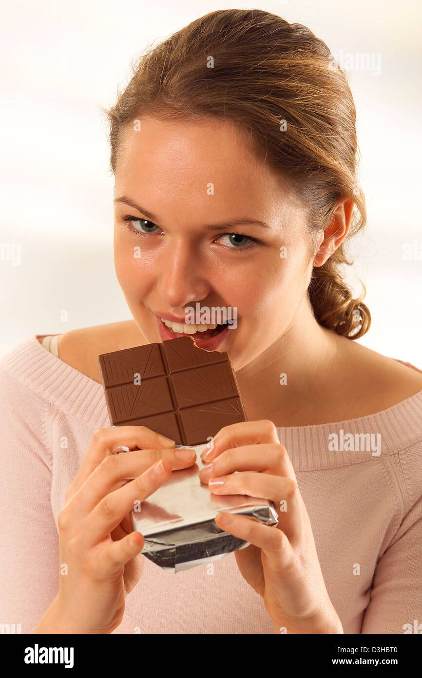 WOMAN EATING SWEETS Stock Photo - Alamy