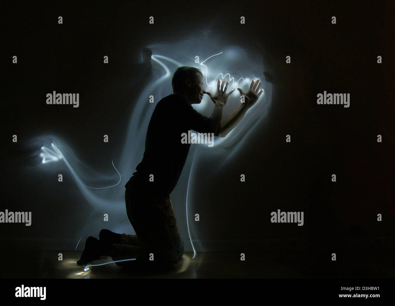 Man devil showing funny faces and gesture kneeling in dark outlined ...