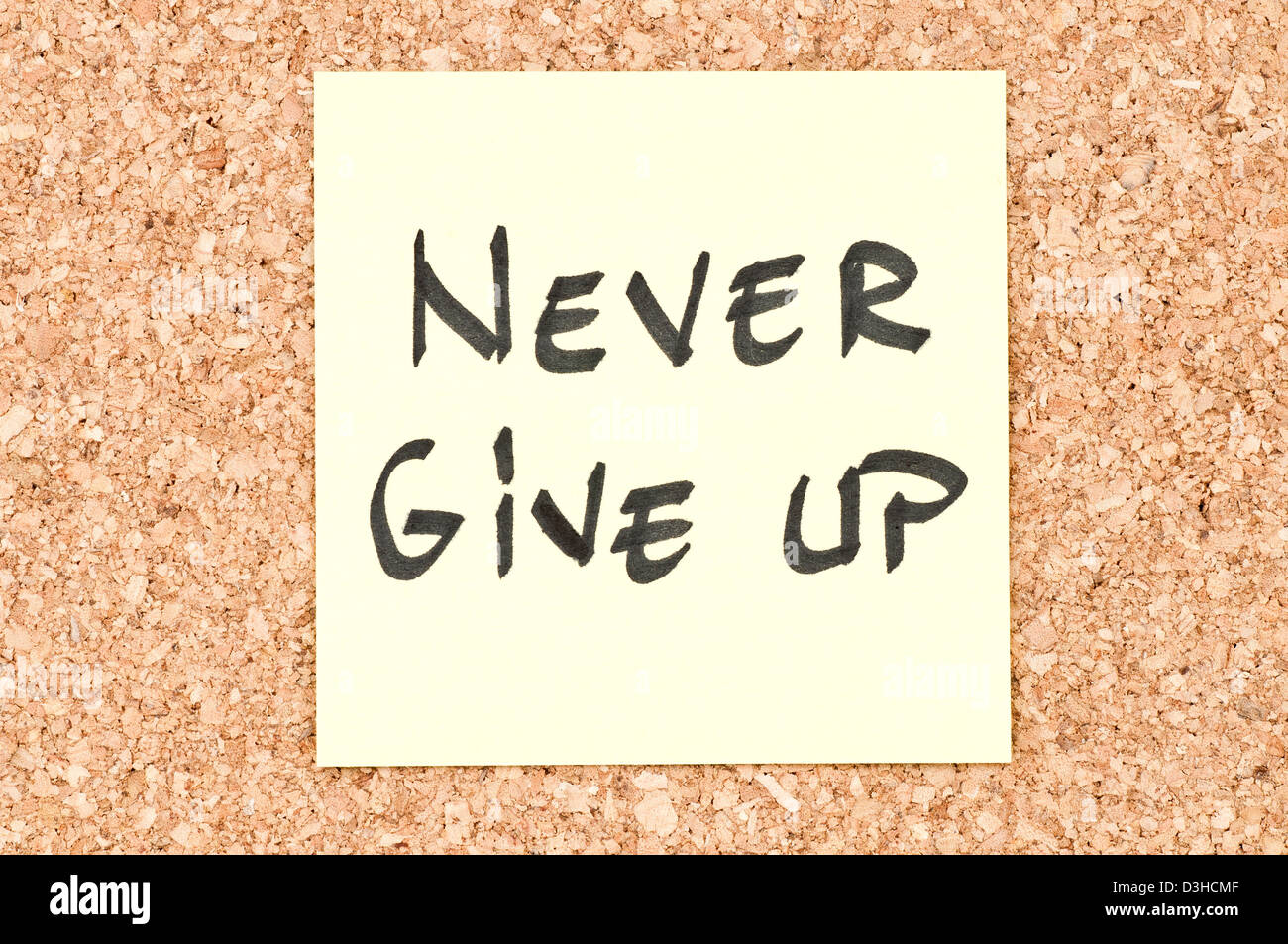 Never Give Up, handwritten on a sticky note Stock Photo - Alamy
