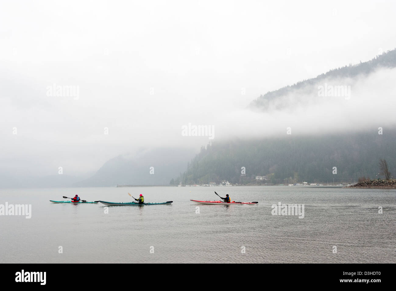 Kayakers paddle out on Harrison Lake at it's southern end, at the ...