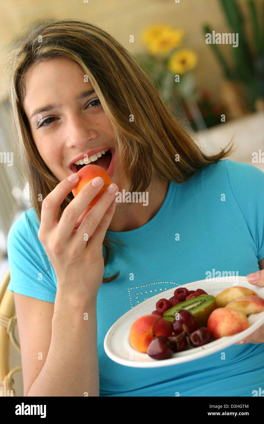 ADOLESCENT EATING FRUIT Stock Photo - Alamy