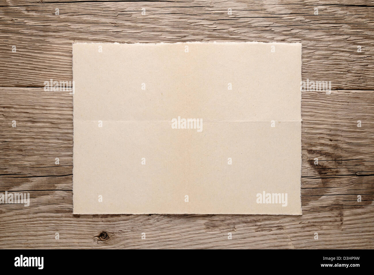 Old paper on wooden background Stock Photo - Alamy