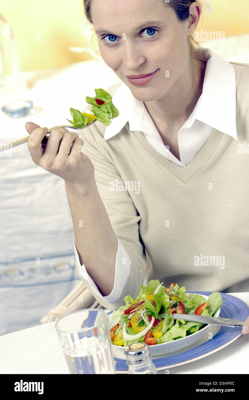 WOMAN EATING RAW VEGETABLES Stock Photo - Alamy