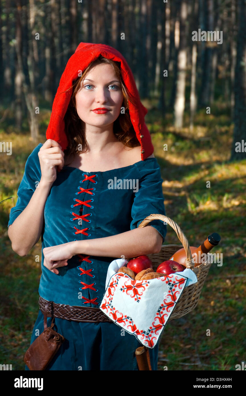 red Riding hood standing in a wood . beautiful girl in medieval dress ...