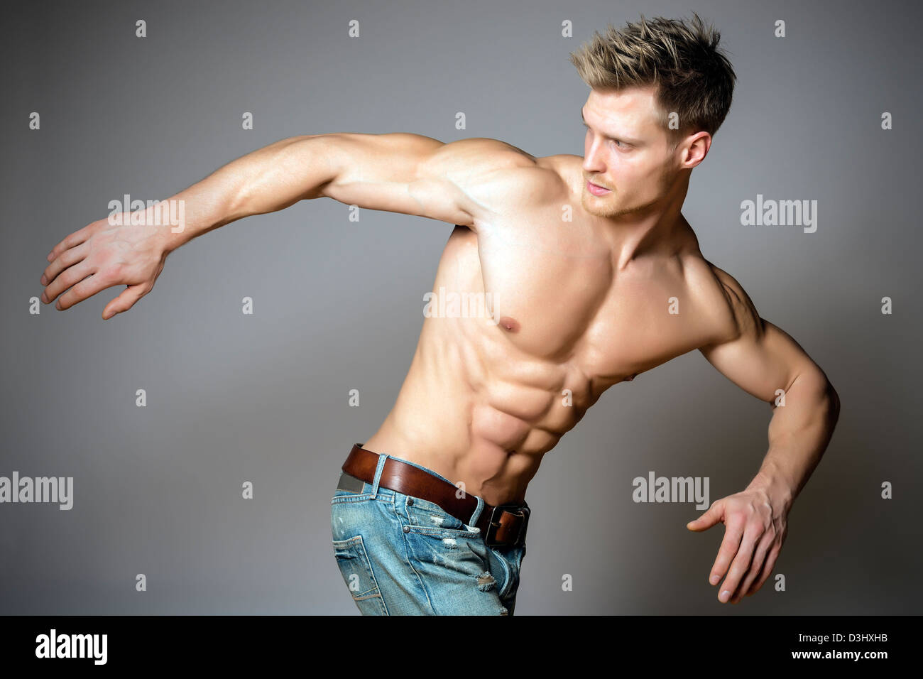 Young and blond athletic man is turning around Stock Photo - Alamy