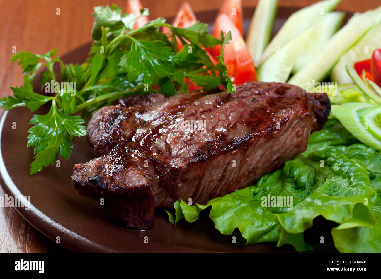 Grilled beef on white plate with vegetable.closeup Stock Photo - Alamy