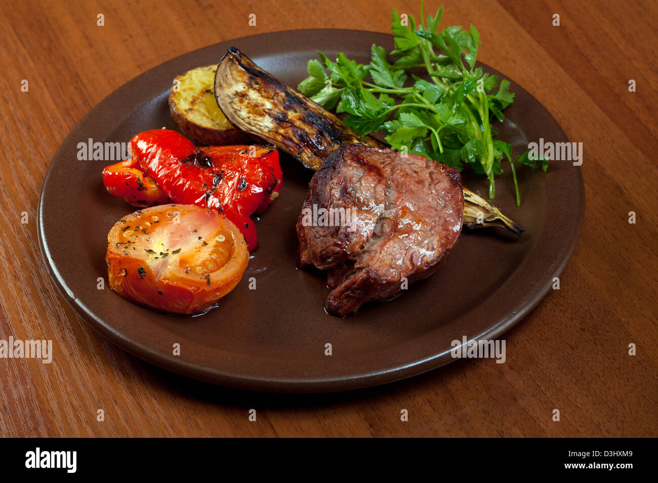 Grilled beef on white plate with vegetable.closeup Stock Photo - Alamy