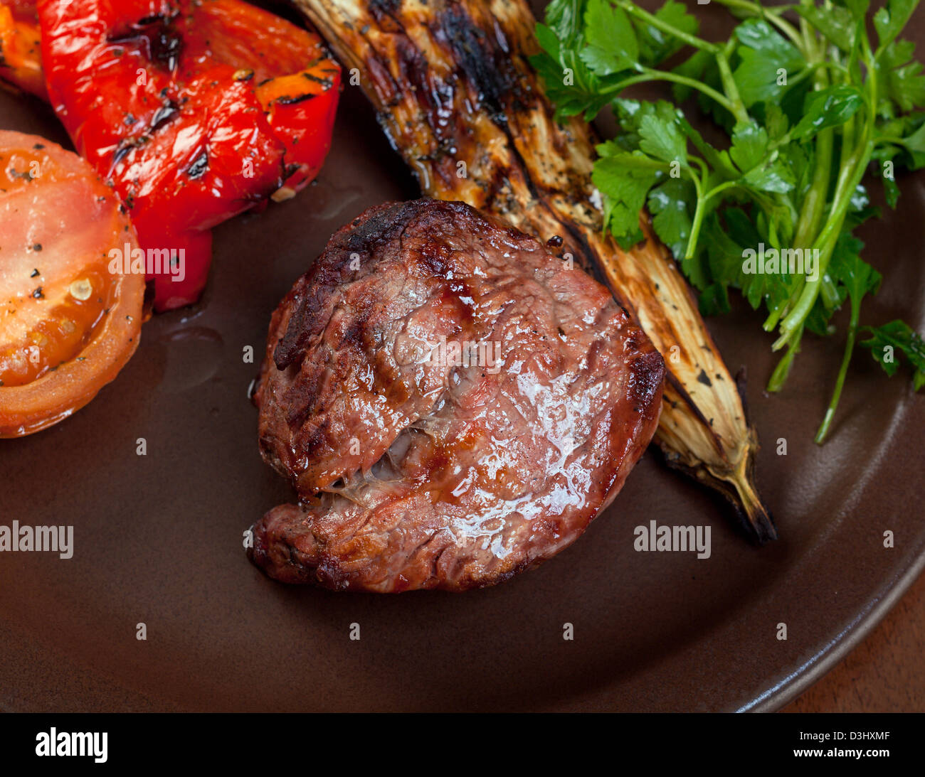 Grilled beef on white plate with vegetable.closeup Stock Photo - Alamy