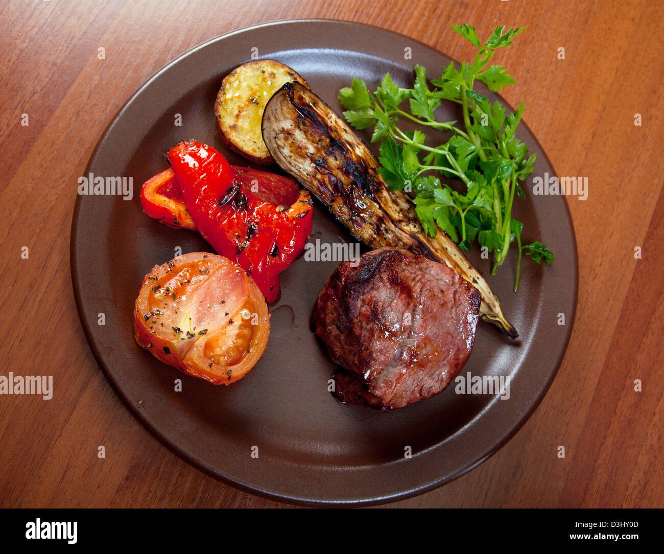 Grilled beef on white plate with vegetable.closeup Stock Photo - Alamy