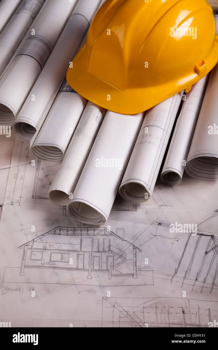 House plan blueprints with yellow hard hat Stock Photo - Alamy