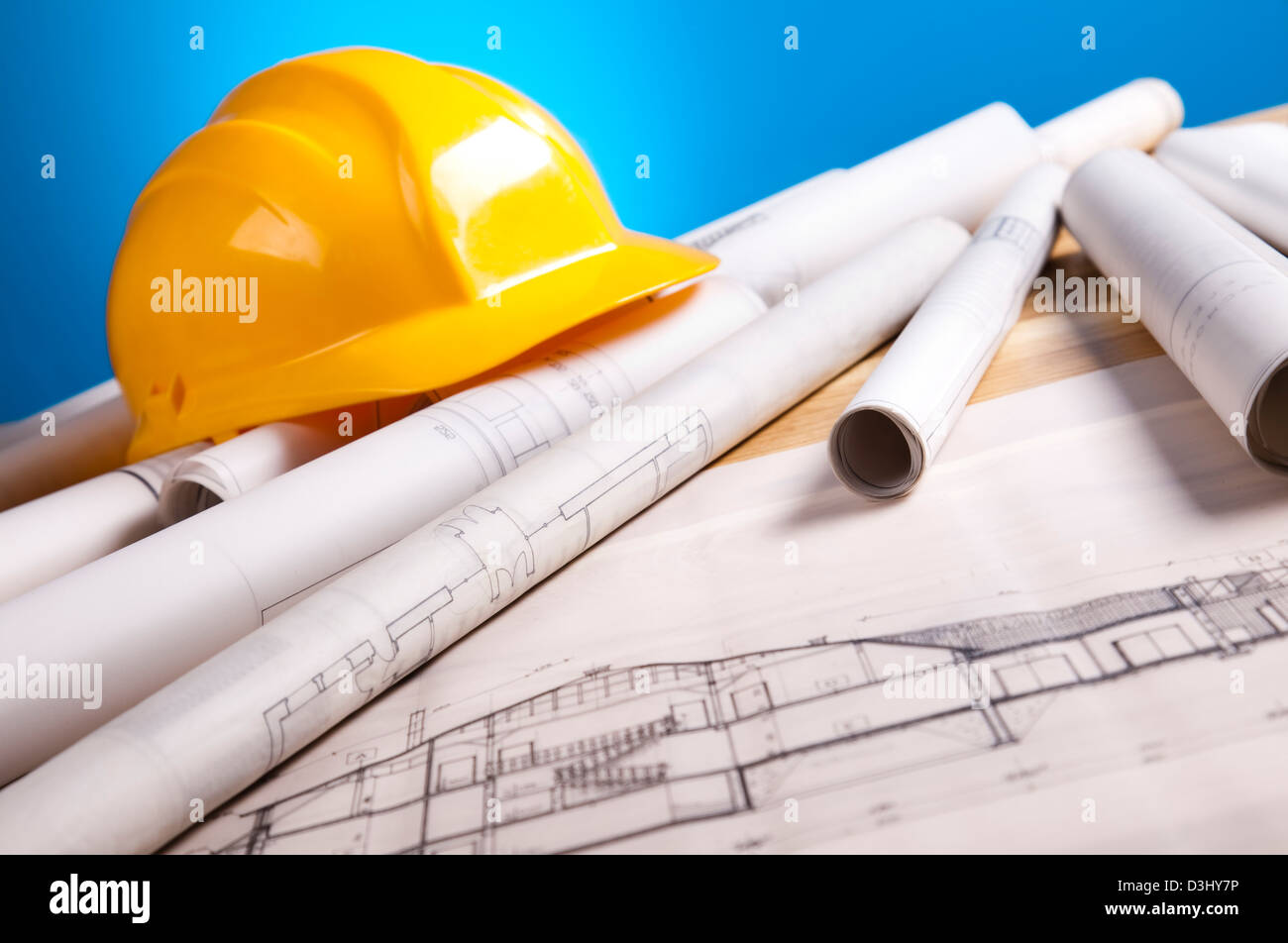 House plan blueprints with yellow hard hat Stock Photo - Alamy