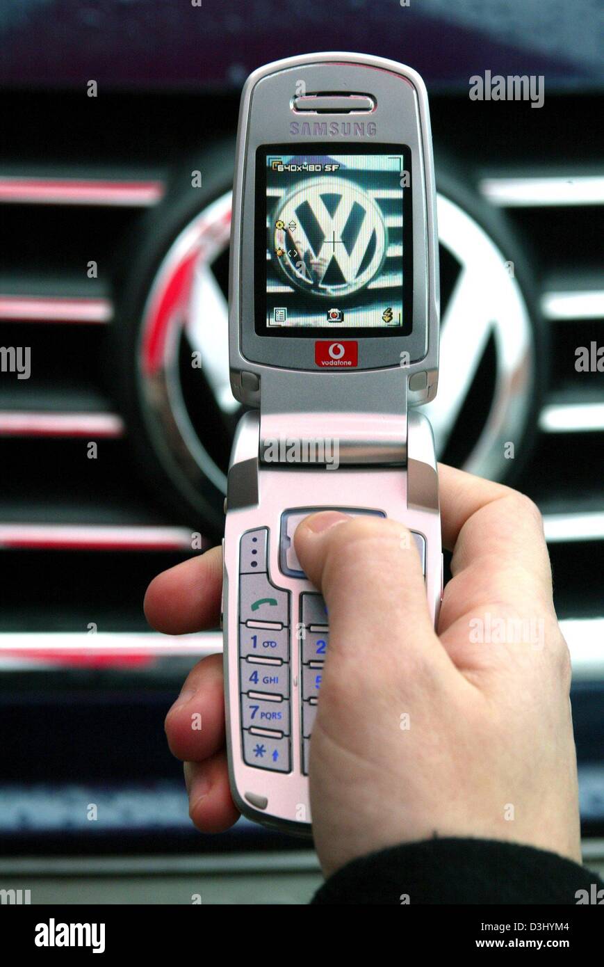 (dpa) - The logo of the car manufacturer VW appears on the display of a ...