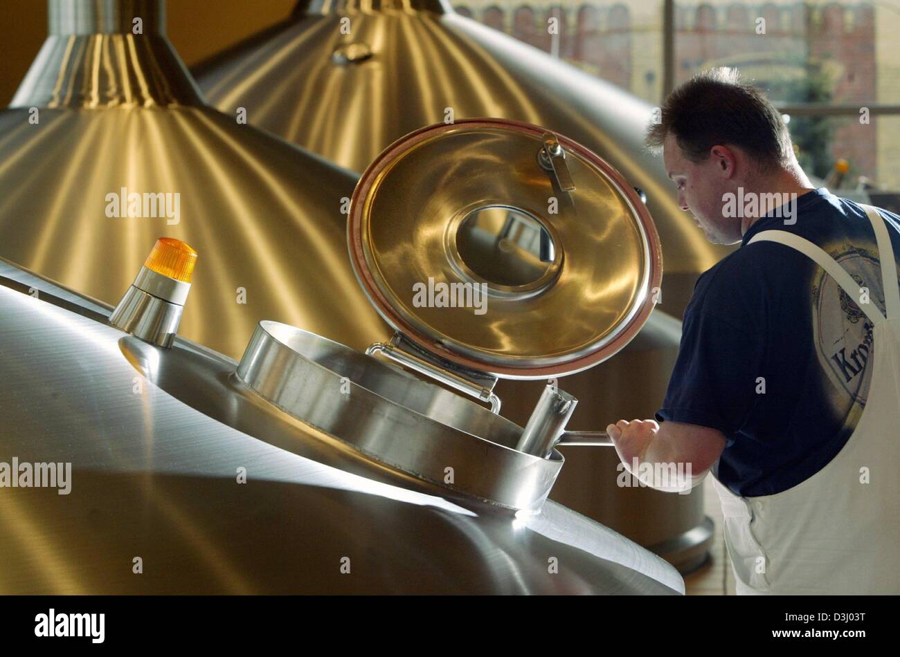 (dpa) - Brewer Thorsten Schreiber collects a sample of beer for tasting ...