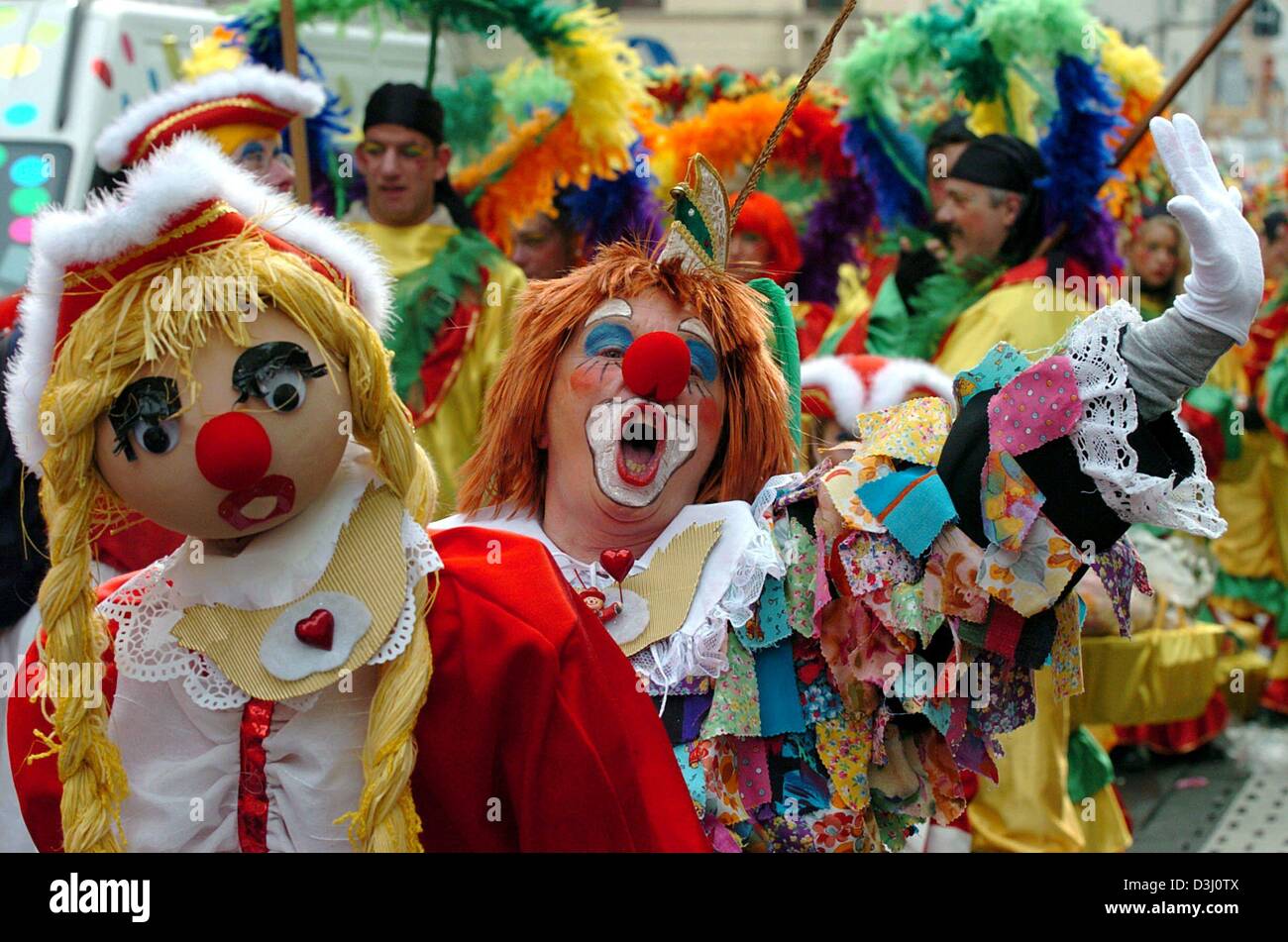 (dpa) - A carnival fool carries a carnival doll during the carnival ...