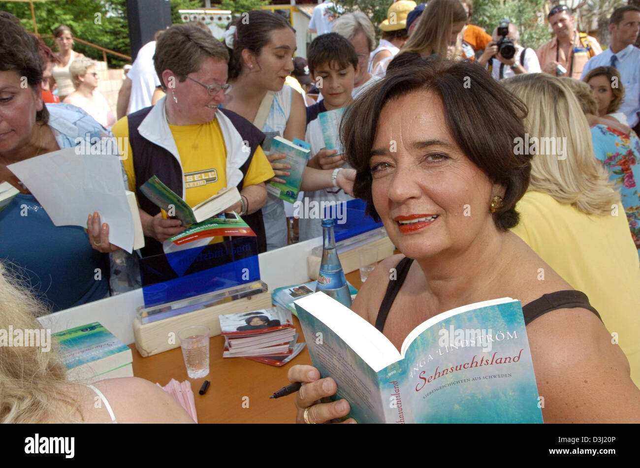 (dpa) - Swedish writer Inga Lindstroem smiles as she signs her ...