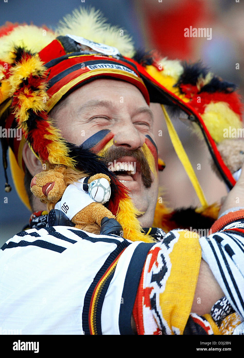 (dpa) - A German soccer fan cheers and smiles after the group A match ...