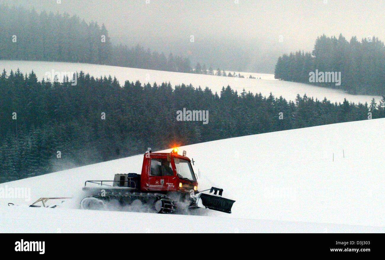 (dpa) - A snow crawler moves slowly through the snow covered winter ...