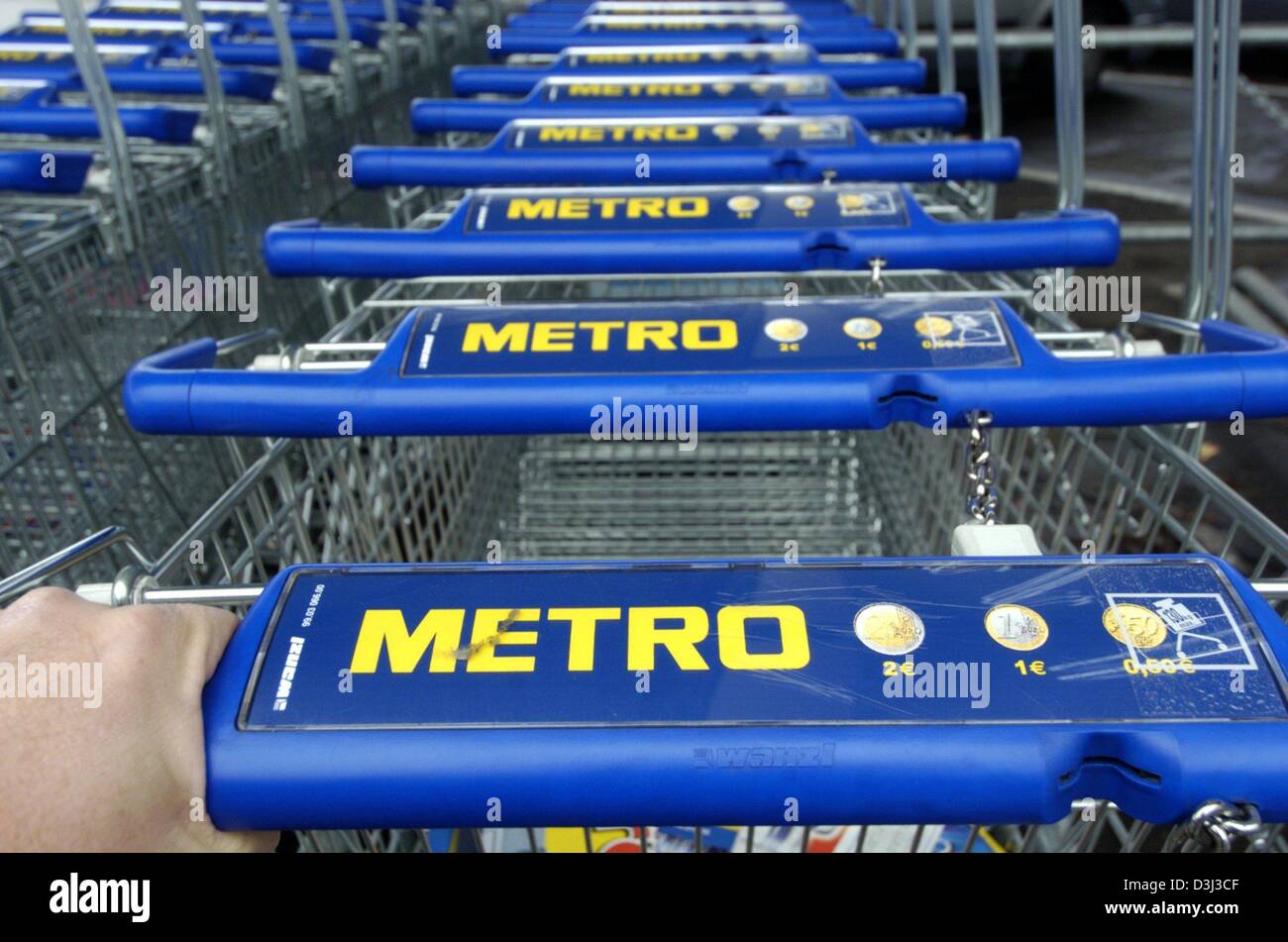 (dpa) - Shopping carts of the German retailer Metro AG are lined up at ...