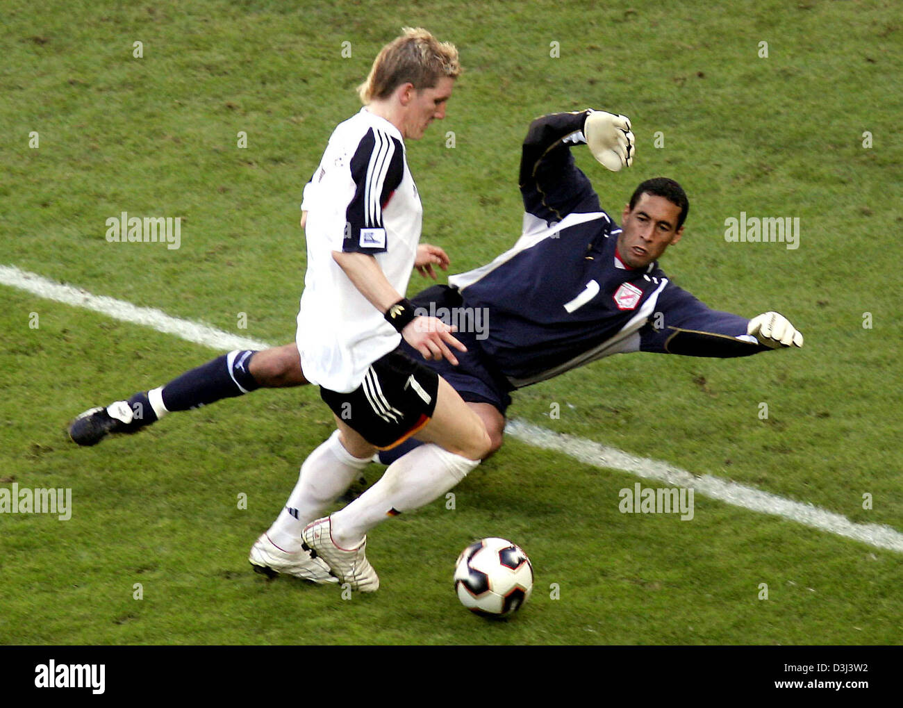 (dpa) - German soccer player Bastian Schweinsteiger (front) scores the ...